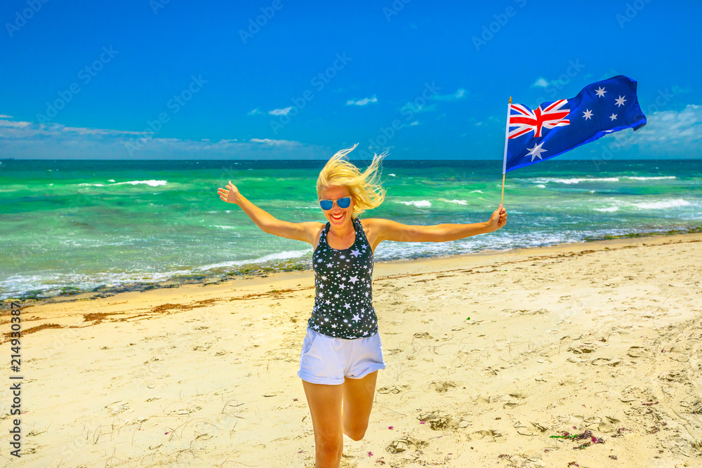 Happy woman running on white beach waving Australian Flag. Blonde ...