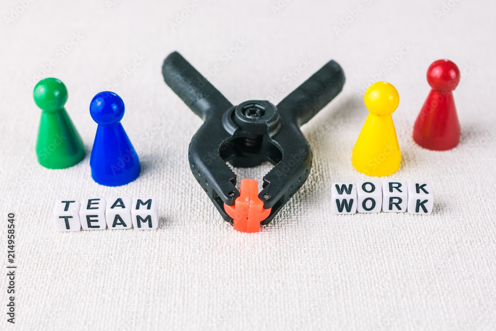 Team work concept - Figures form with clamp tool as symbol for a ...