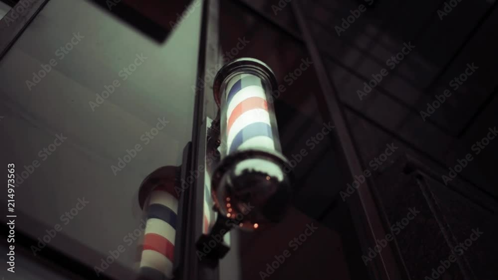 Barber pole rotating on wall in hairdresser shop. Barber pole spinning ...