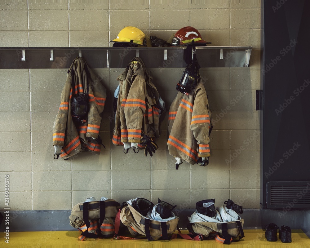 Firefighter hat and gear hanging in the fire stastion Stock Photo ...