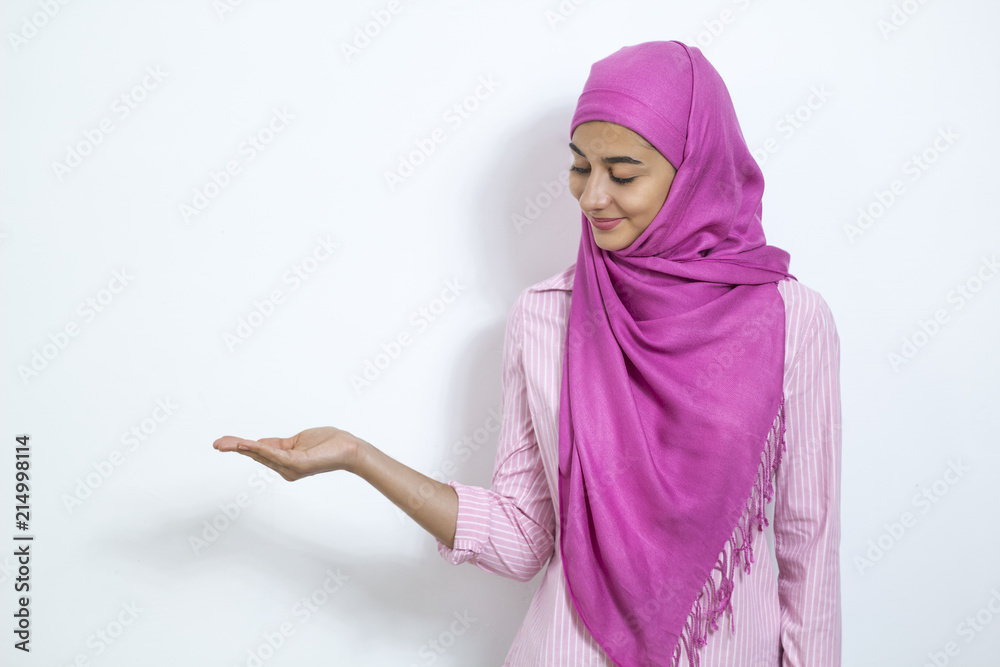 Muslim girl in hijab shows her hands copy space. Arab young woman ...