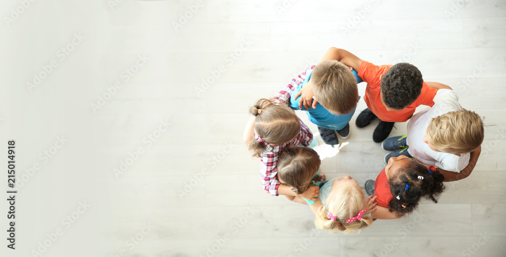 Little children making circle with hands around each other indoors, top ...