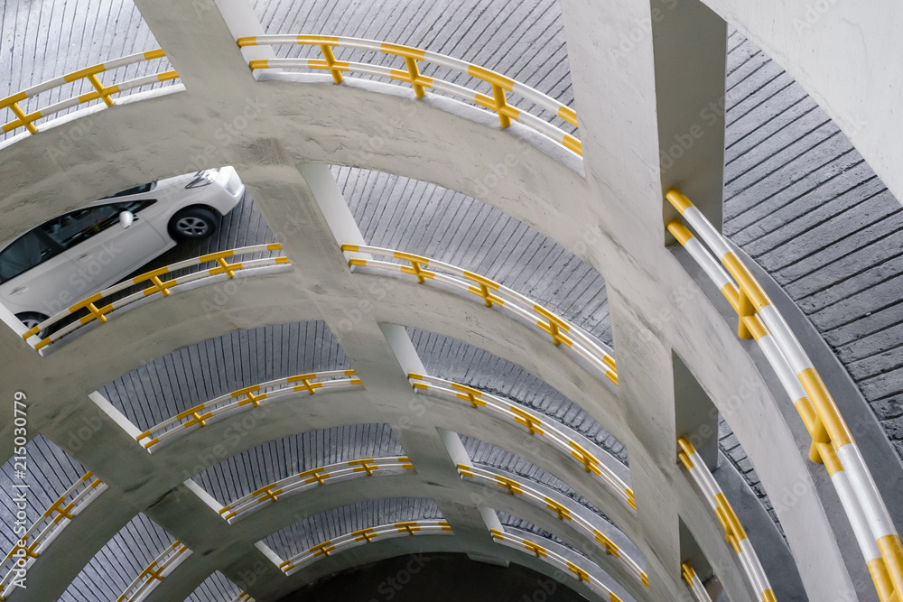 car climbing up a slope of spiral path for parking space, long exposure ...