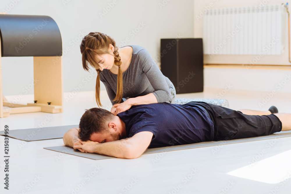 Back pain. Rehabilitation, back pain. Female instructor relaxing ...