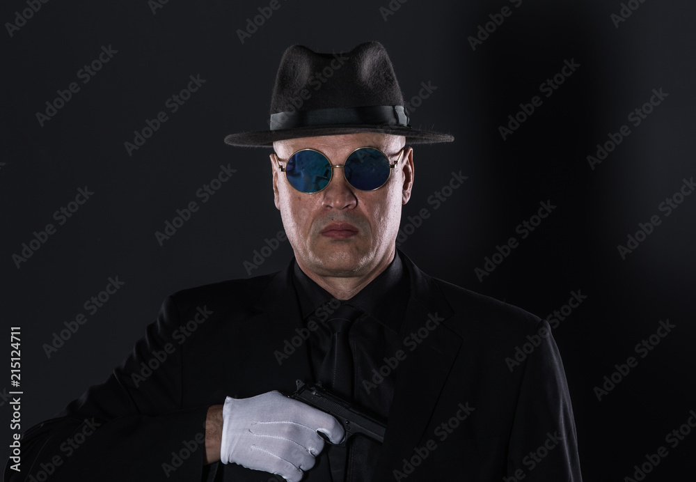 bald man with a gun Stock Photo | Adobe Stock