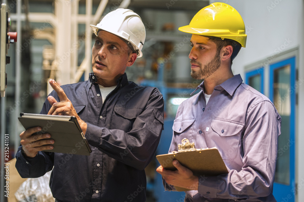 Factory workers examining control panel in factory Stock Photo | Adobe ...