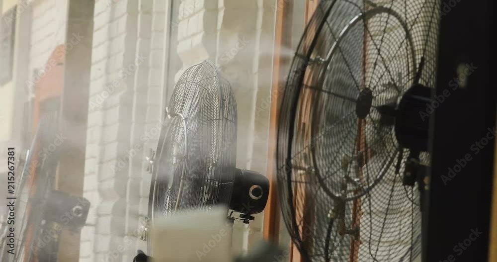 Street cooling system with spray nozzles water and fan. Water Vapour ...