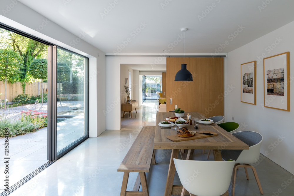 Contemporary dining room with views to the garden through large glass ...