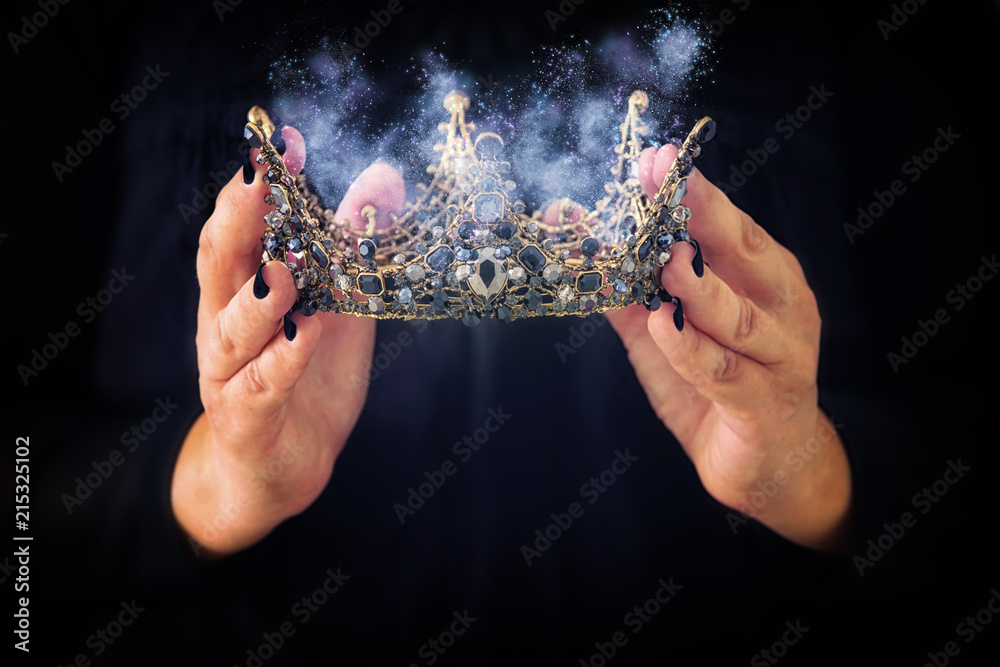 image of lady in black holding queen crown decorated with precious ...