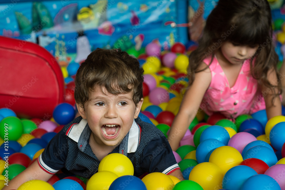 Happy children having fun at kids indoor play center. Kids playing with ...