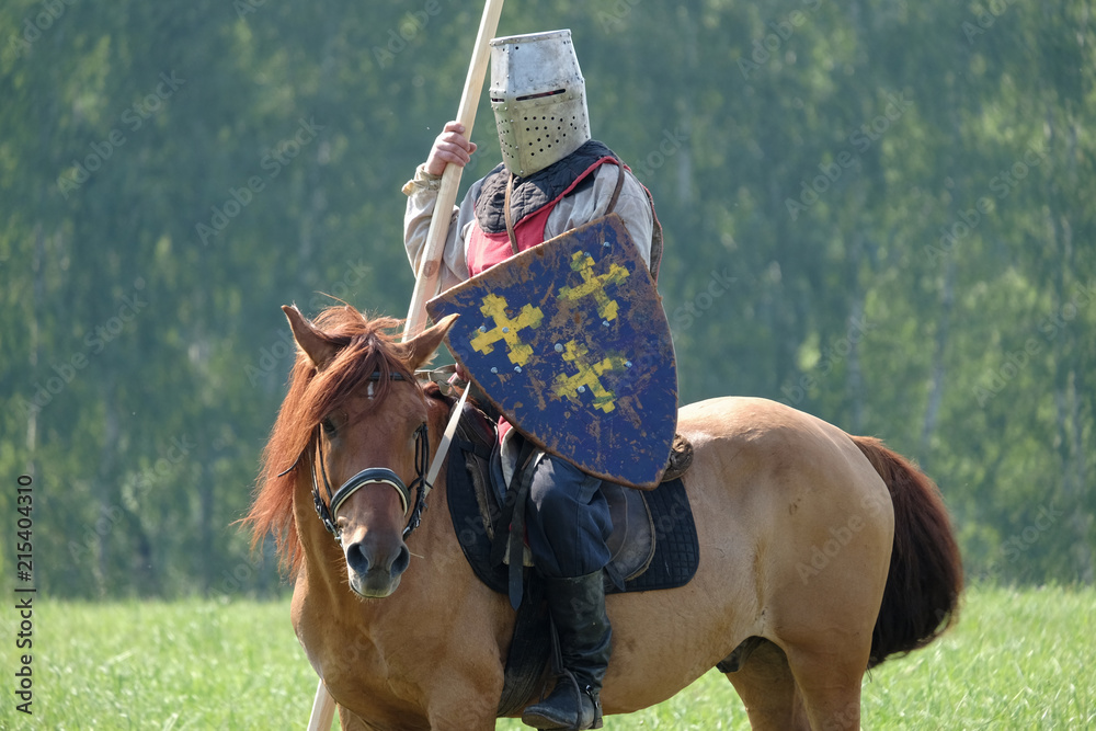 medieval knight with a spear riding a horse Stock Photo | Adobe Stock