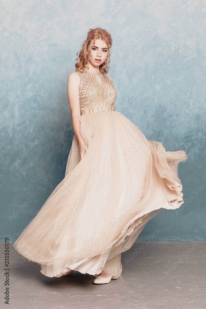 Fashion model in beautiful luxury beige flowing chiffon dress, Woman in ...