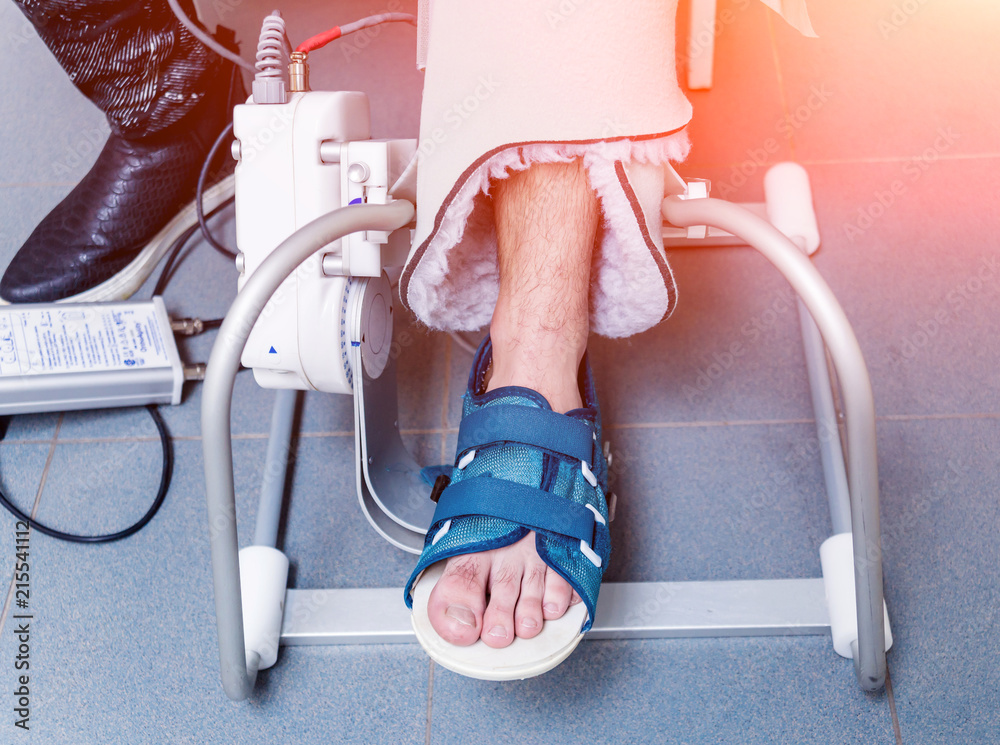 Patient on CPM (continuous passive range of motion) machines. Device to ...