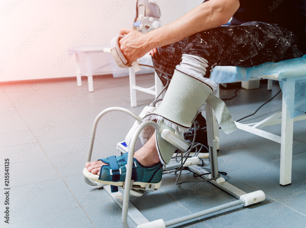 Patient on CPM (continuous passive range of motion) machines. Device to ...