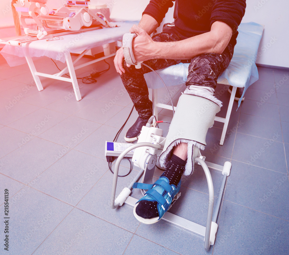 Patient on CPM (continuous passive range of motion) machines. Device to ...