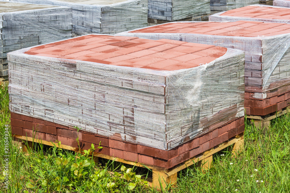 Red paving slab on pallets, red paving brick Stock Photo | Adobe Stock