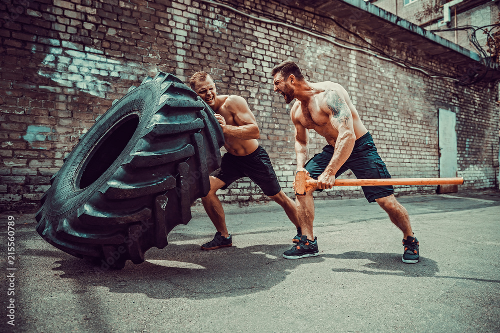 Two muscular athletes training. Muscular fitness shirtless man moving ...