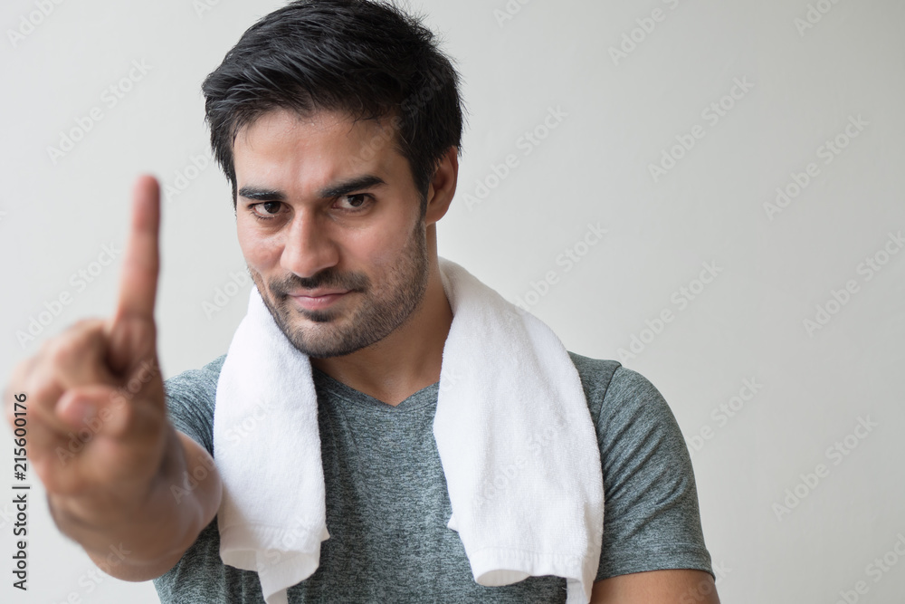 fitness man with discipline pointing up one finger; portrait of serious ...