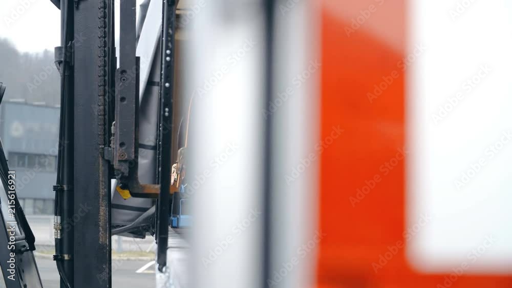 Unloading trailer cargo with forklift dolly slide 4K. Long dolly shot ...