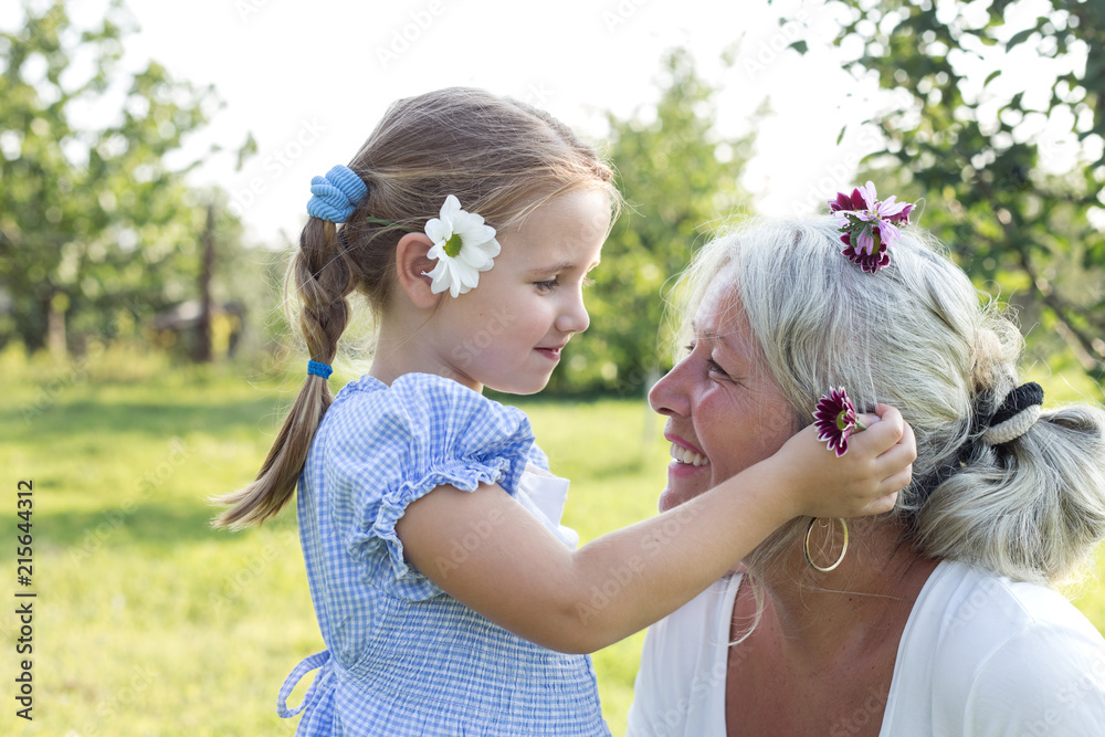 Child and grandmother are playing in nature Stock Photo | Adobe Stock