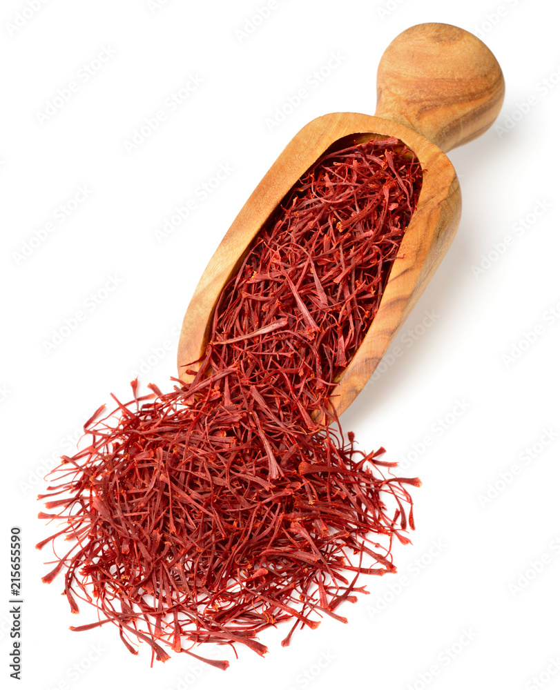 saffron thread in the wooden scoop, isolated on the white background ...