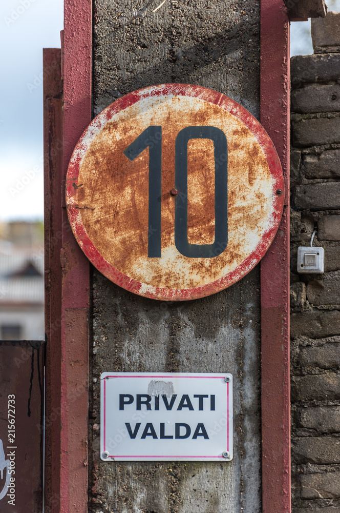 Old road speed limit sign and plate with signage "Privati valda ...