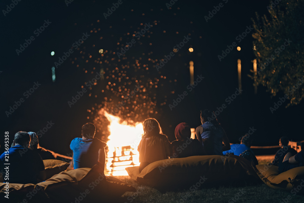 Group of people near camp fire with campfire song and campfire meals ...