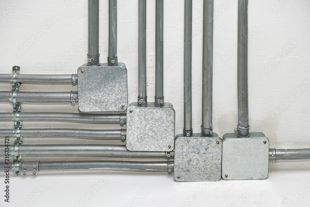 Metal Pipes Electrical Wires with join and control box in home Stock ...
