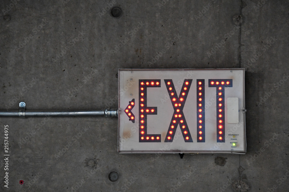 Exit Sign and conduit on wall Stock Photo | Adobe Stock