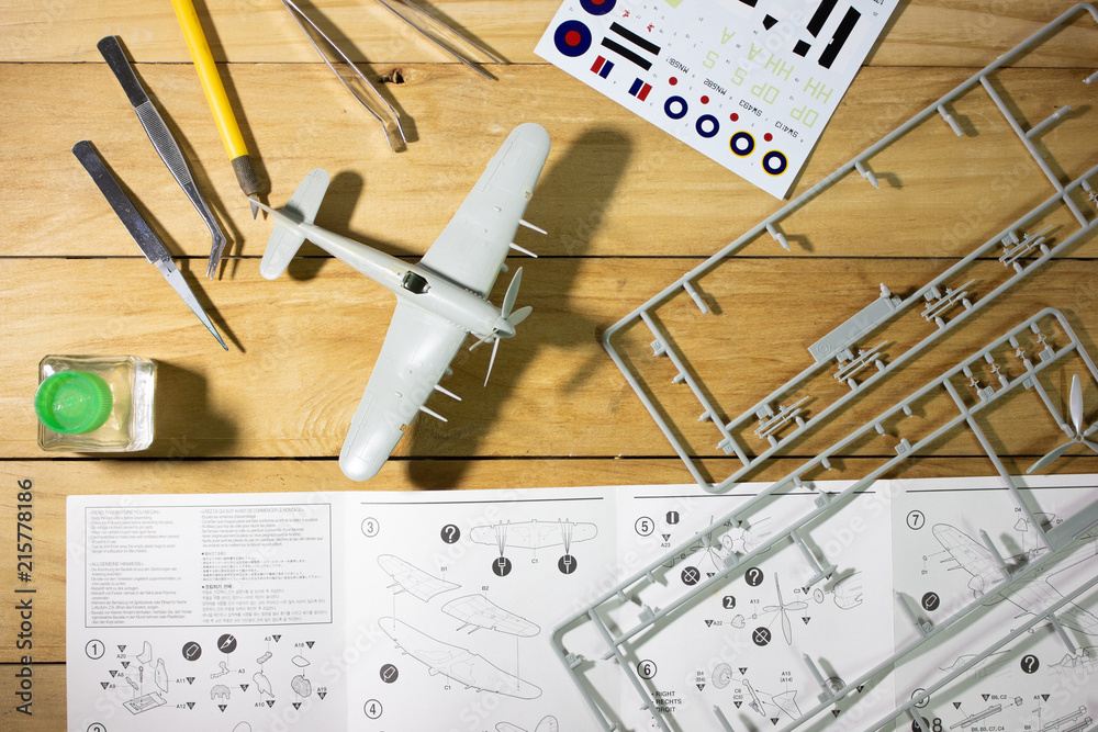 Scale model WW2 fighter plane building on wooden table with scale ...