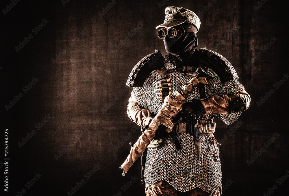 Post apocalyptic soldier in black mask and glasses, wool field cap and ...