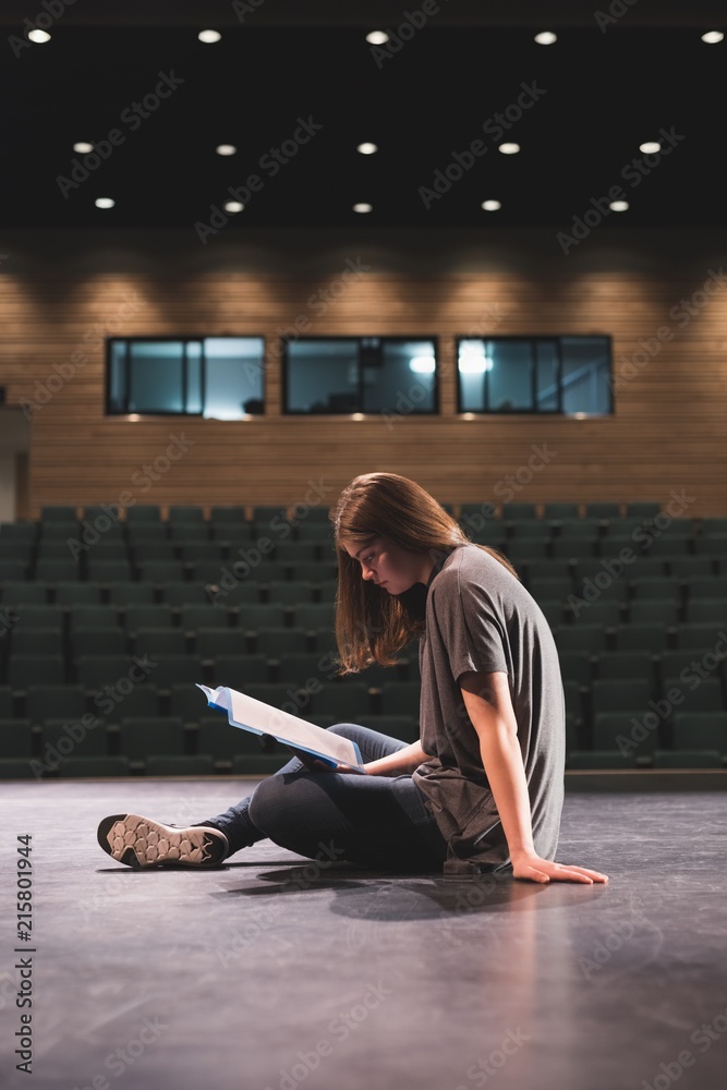 Female actress reading script on stage Stock Photo | Adobe Stock