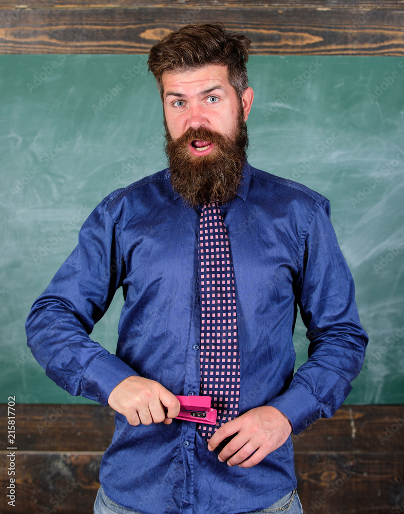 School accident prevention. Teacher bearded man with pink stapler ...