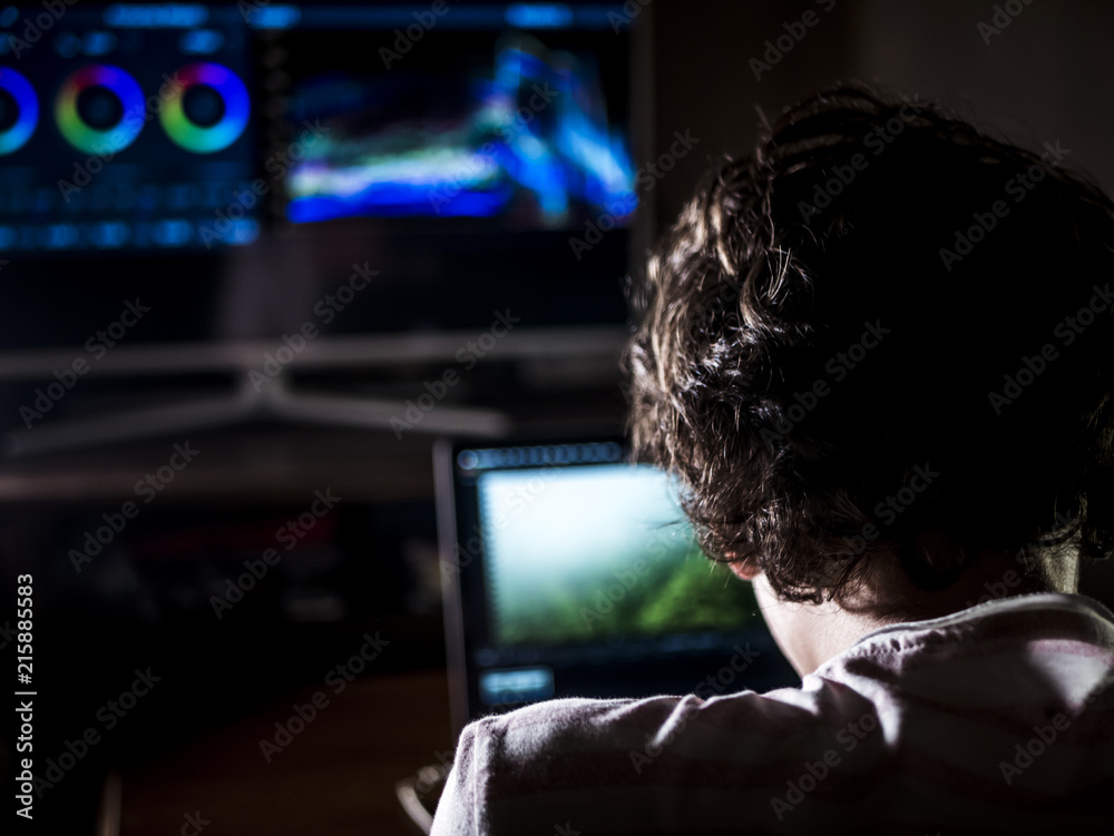 back view of young man in the dark studio color grading video with ...