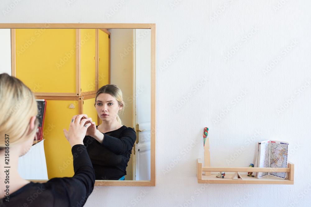 Girl touching mirror surface with arm. Stock Photo | Adobe Stock