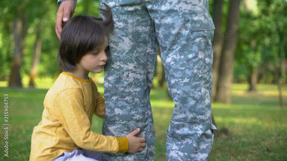 Sad boy hugging soldier, child missing father, family separation ...