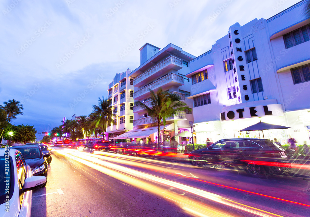 Ocean Drive scene at sunset with lights, palm trees, cars and people ...
