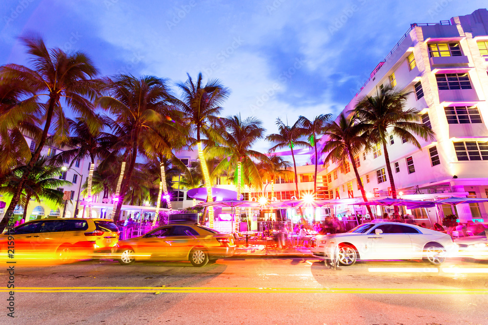 Ocean Drive scene at sunset with lights, palm trees, cars and people ...