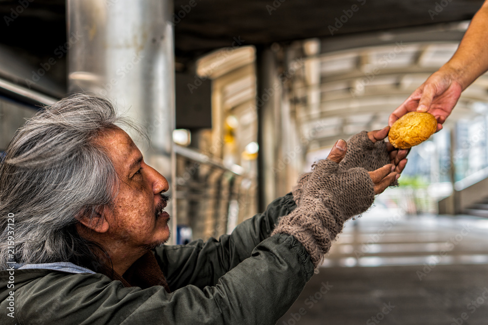 Homeless male with happy face showing hands to recieve bread from ...
