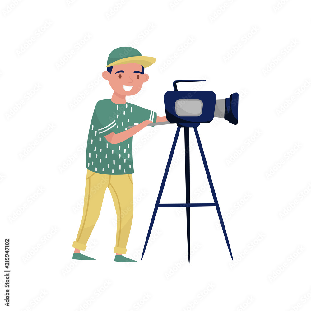 Young man looking through video camera on tripod. Cameraman making ...