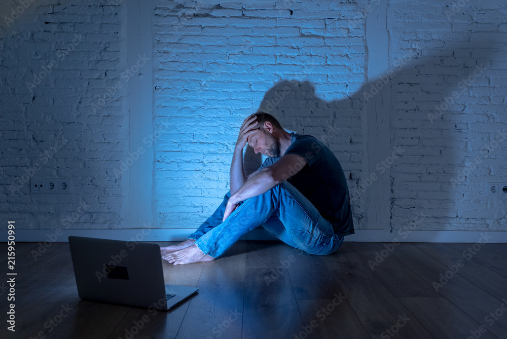 Severely distraught young men with computer laptop suffering ...