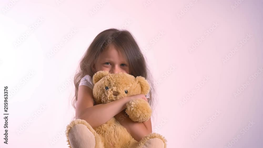 Vidéo Stock Little cute girl hugging her plush teddy bear, kid ...