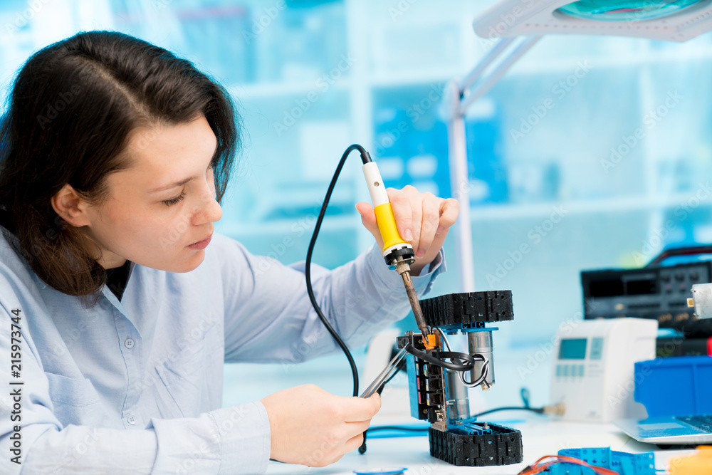 Student girl in electronics laboratory, experiment with microcontroller ...