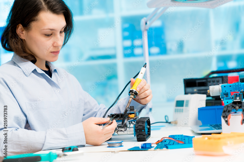 Student girl in electronics laboratory, experiment with microcontroller ...