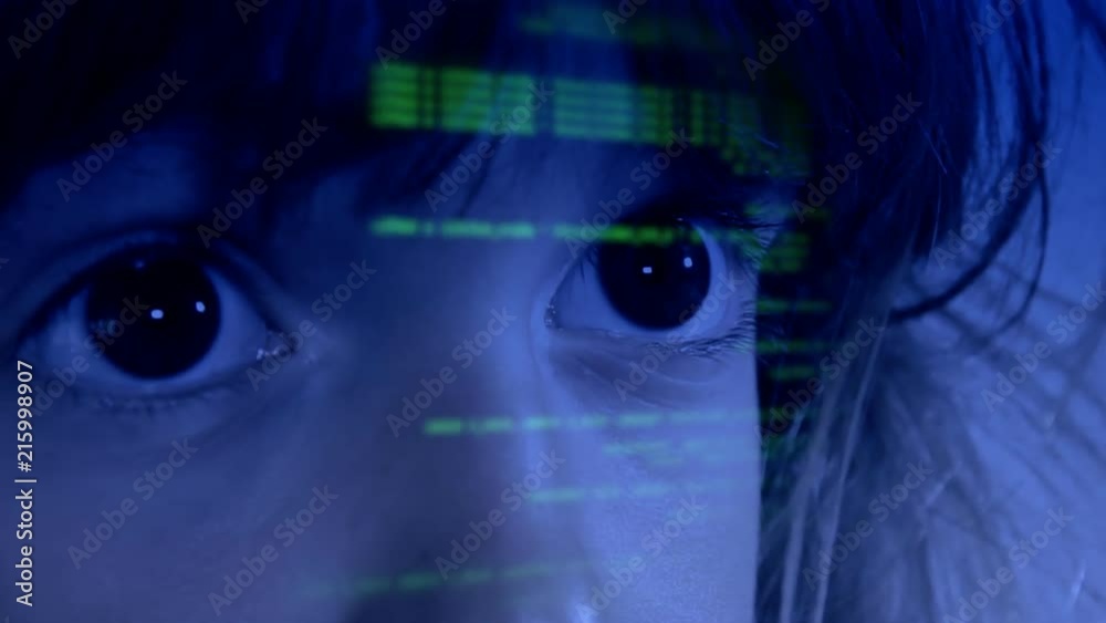 The eyes of a cute little girl browsing computer source code, green ...