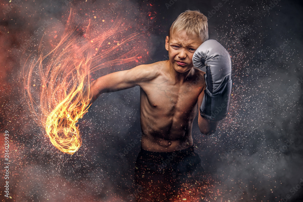 Shirtless young boxer with blonde hair wearing boxing gloves shows a ...