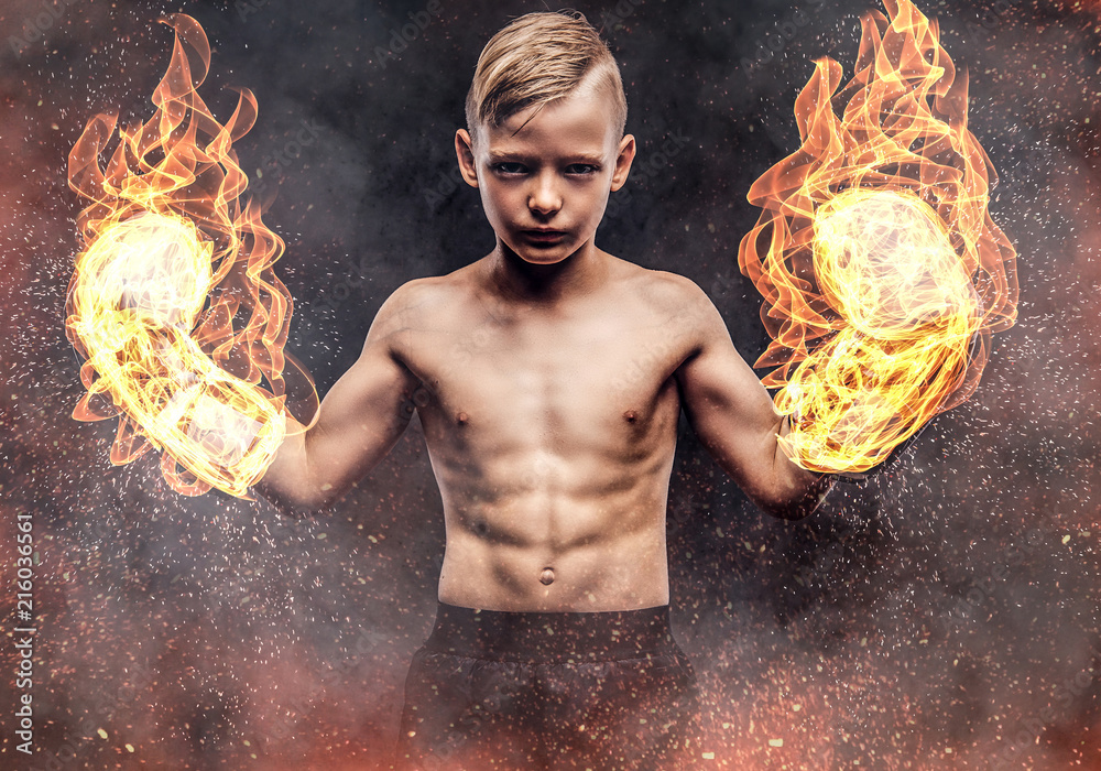 Young shirtless boy boxer wearing burning boxing gloves posing on the ...