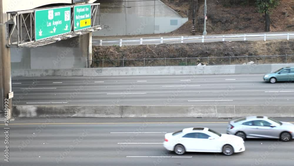 SLOW MOTION side view of the freeway overpass in Los Angeles near the ...
