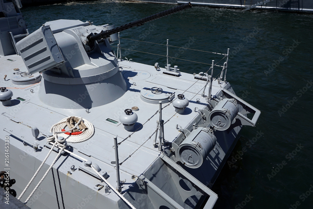 Naval ship artillery gun barrel on a blue sea background. copy space ...
