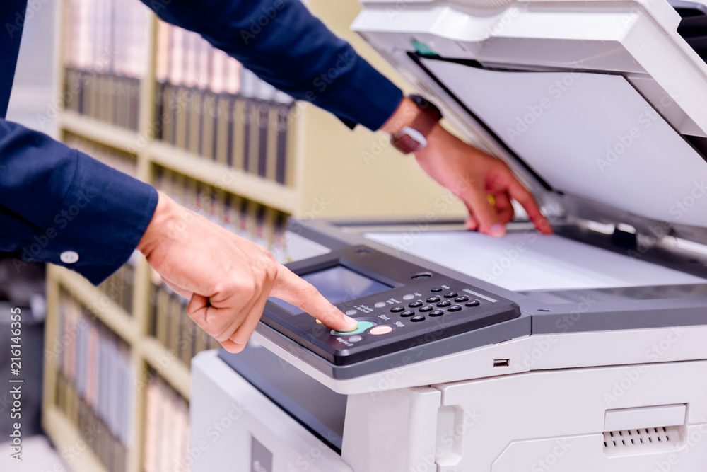 Bussiness man Hand press button on panel of printer, printer scanner ...